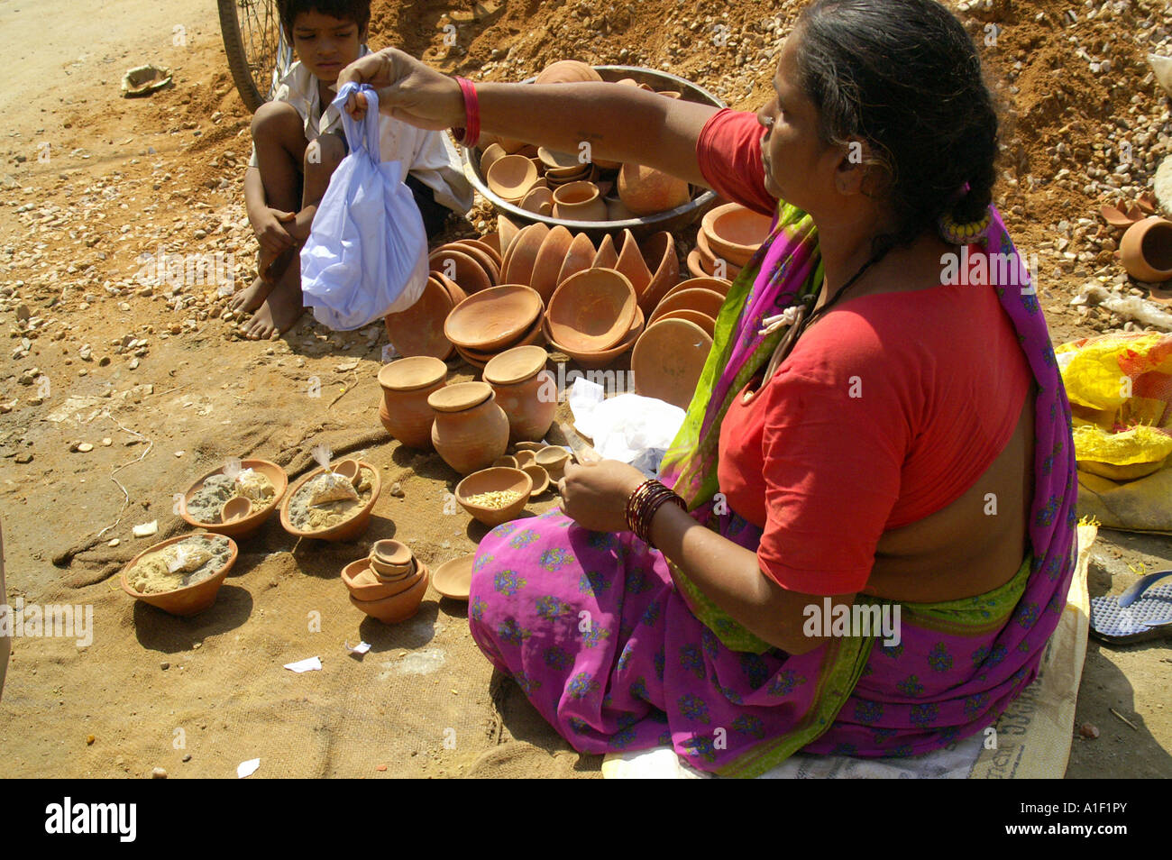 Old woman selling pottery at street of Nw Stock Photo - Alamy