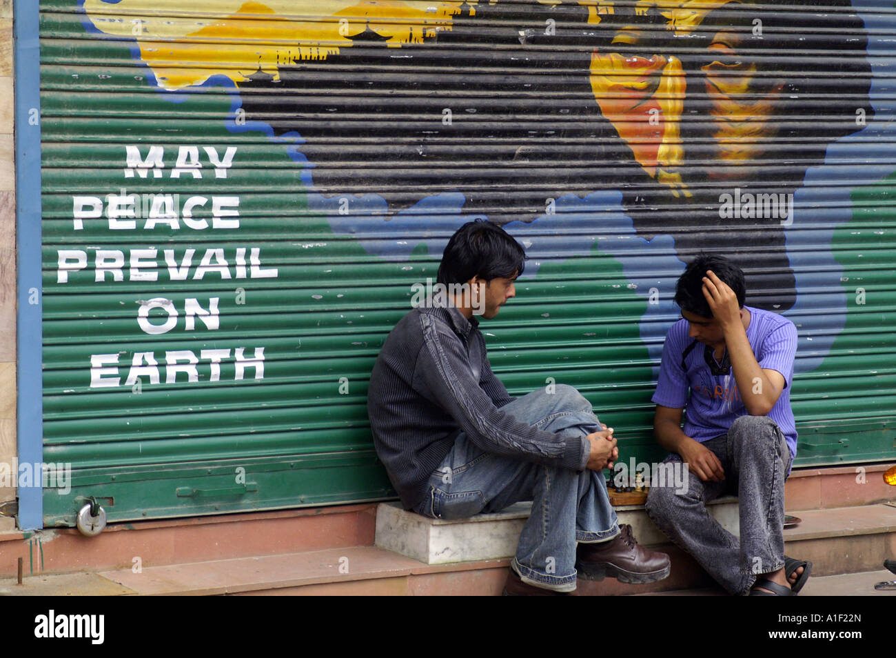 Two indian boys playing chess under stylised face painting in McLeod ...