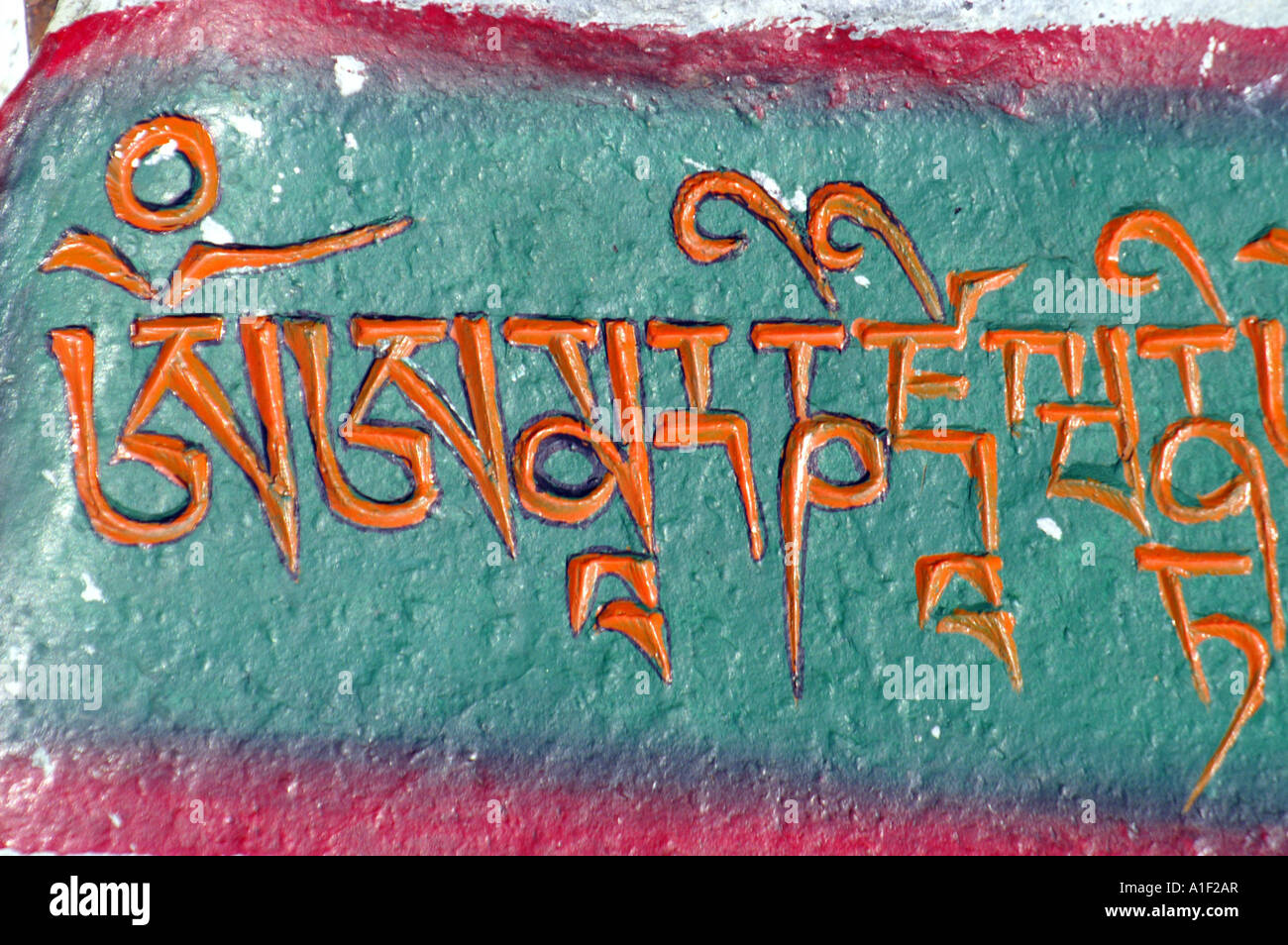 Om mani padme hum colourful sign on Mani stone, McLeod Ganj, India ...