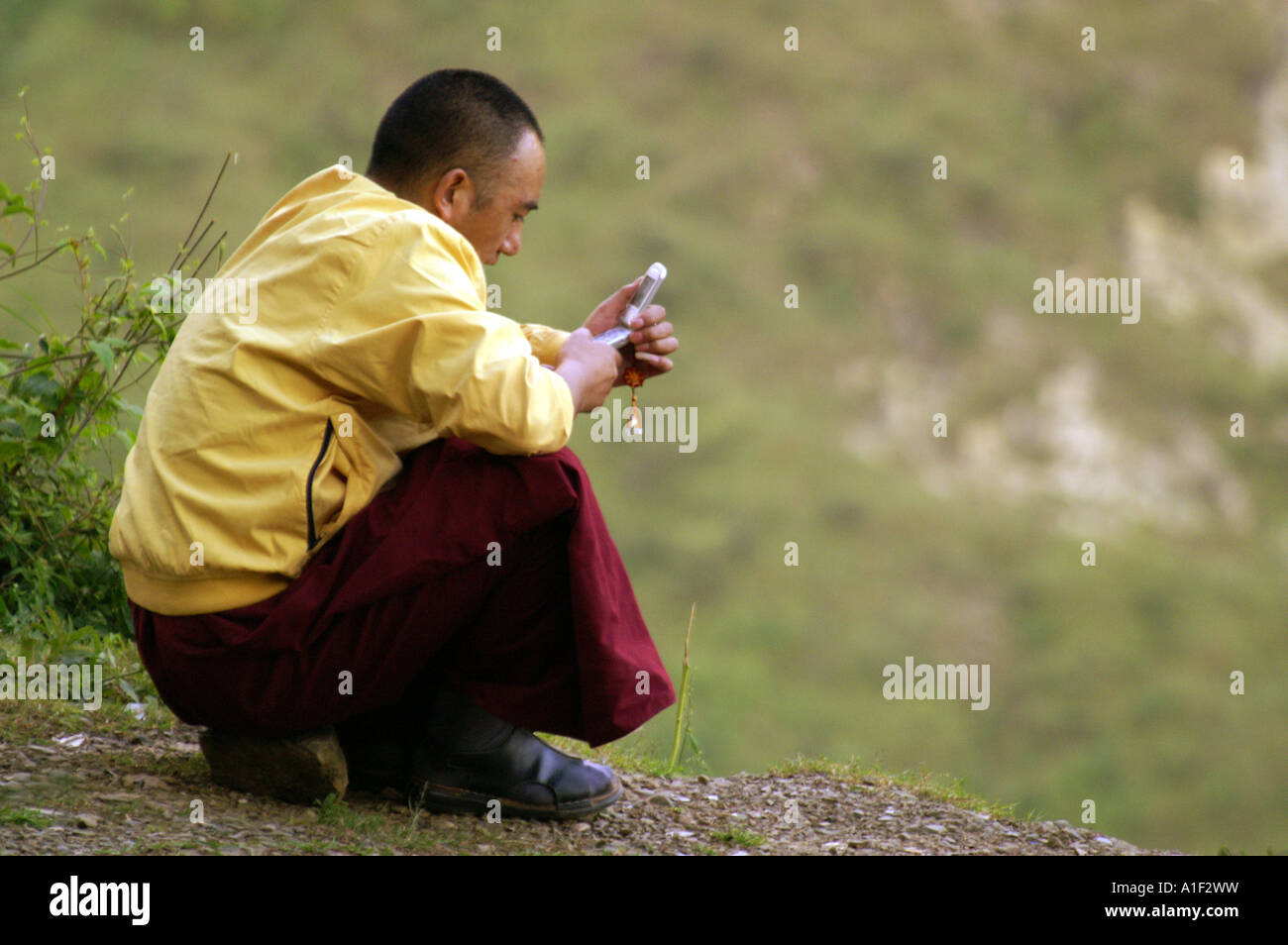 Young tibetan monk using mobile phone Stock Photo - Alamy