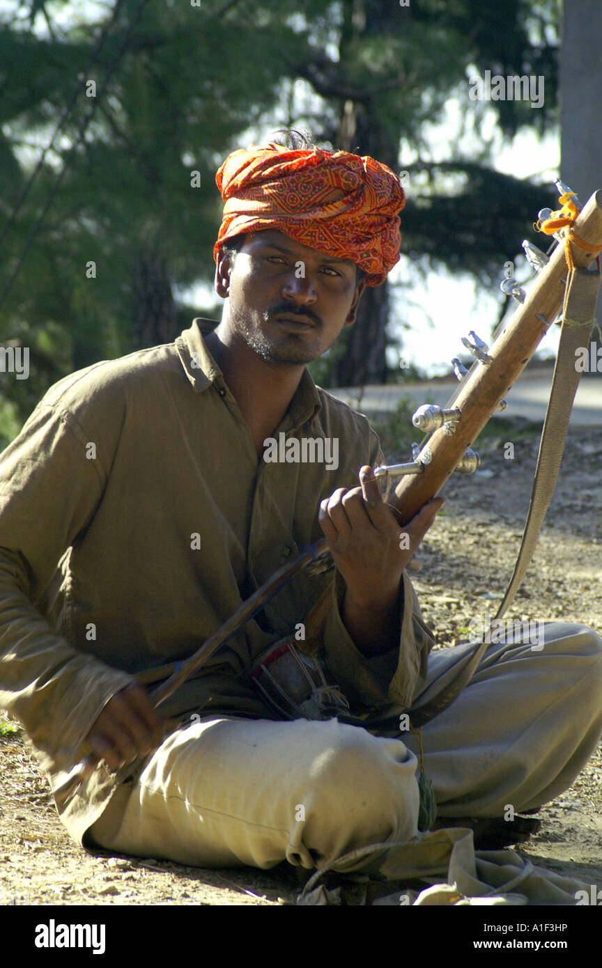 Indian man playing sort of sitar music instrument outdoors Stock Photo ...