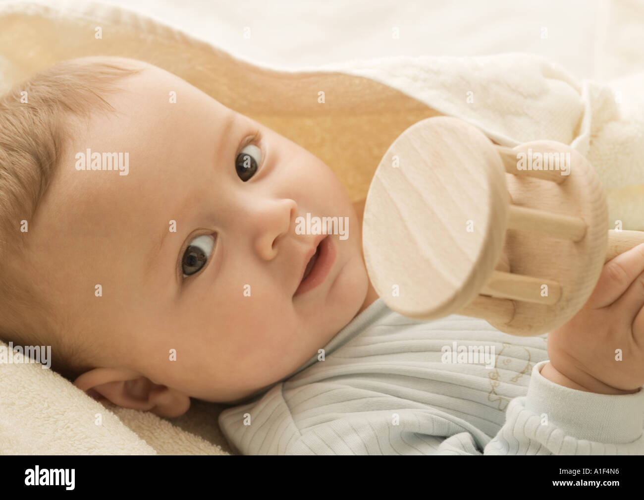 Baby holding toy rattle hi-res stock photography and images - Alamy