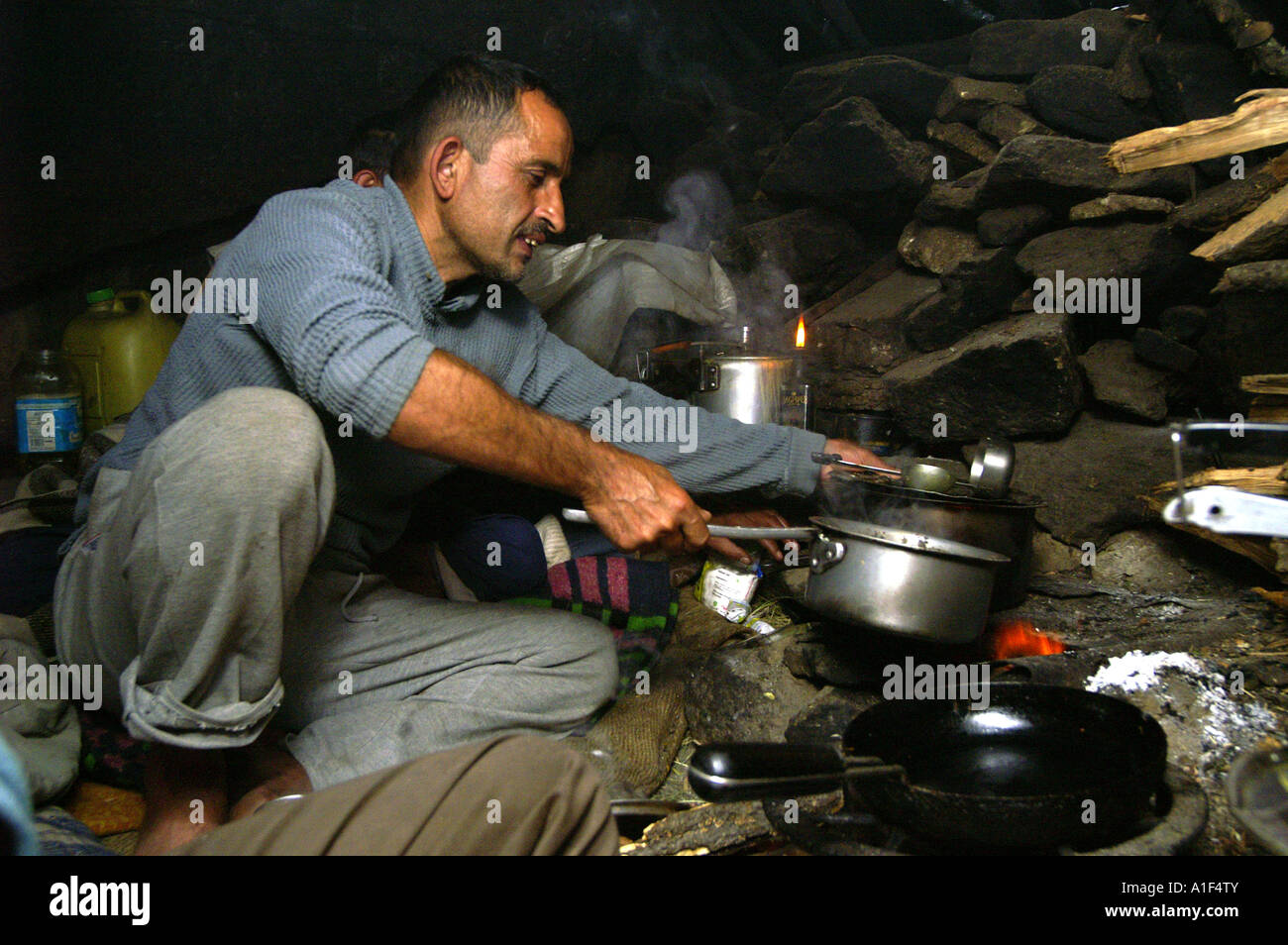 Indian man cooking indoors in pressure cooker Stock Photo - Alamy