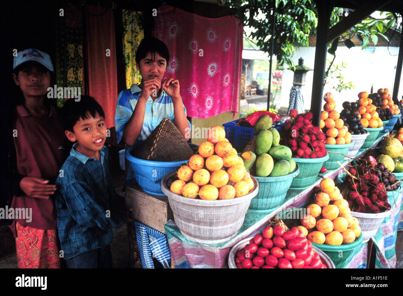Children selling fruit on the roadside Bali Indonesia Stock Photo - Alamy