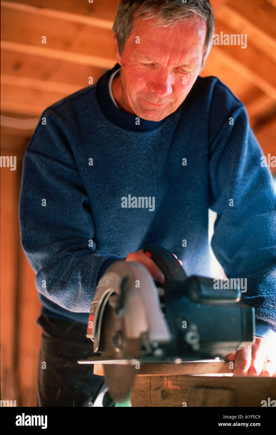 A 64 year old man using a circular saw Stock Photo - Alamy