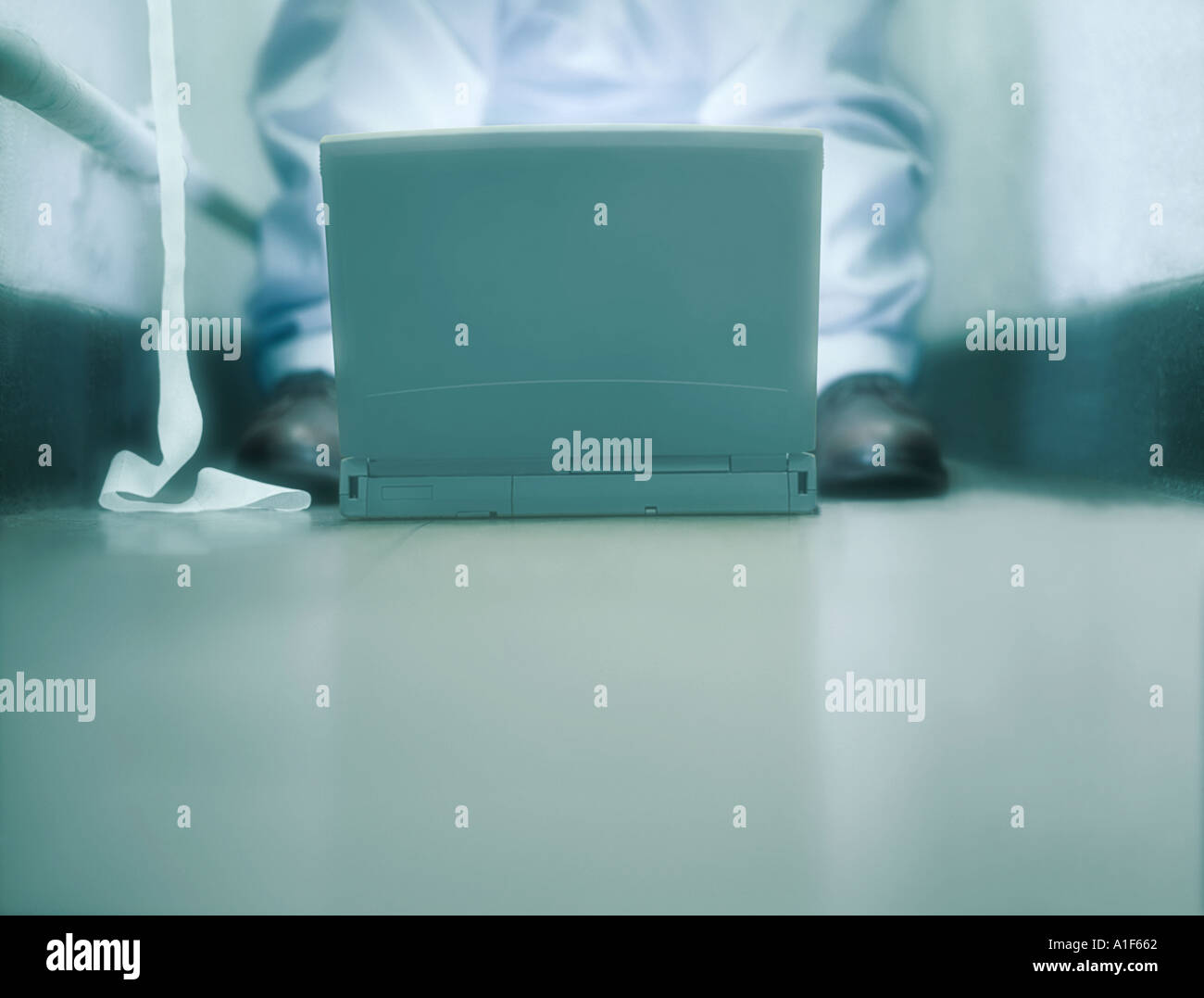 Man in restroom with laptop, low section Stock Photo - Alamy