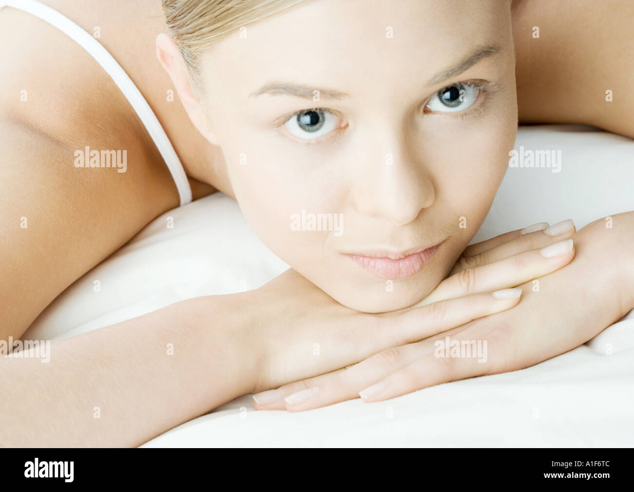 Woman resting head on hands Stock Photo - Alamy