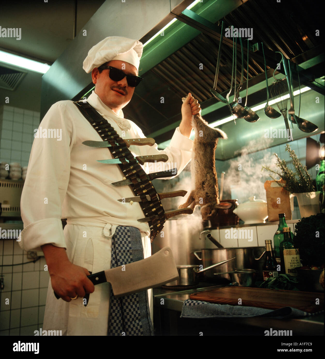 a dangerous looking cook with sunglasses, staying in the kitchen with a ...