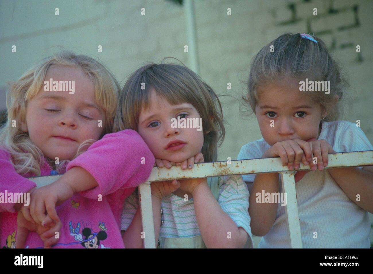 three little girls taking a rest from play Stock Photo - Alamy