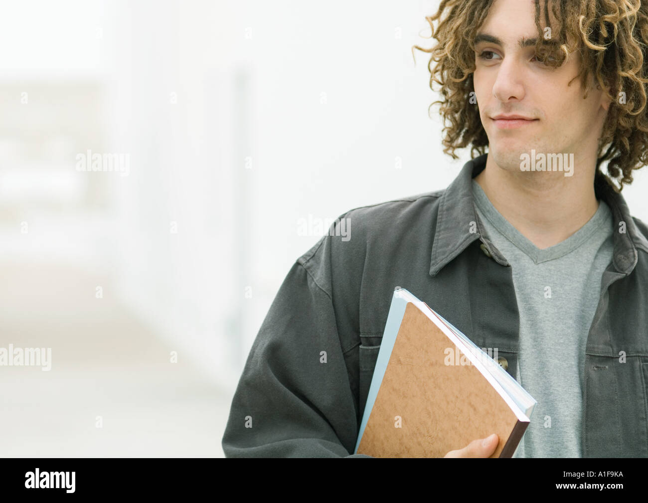 Boy holding textbook front class hi-res stock photography and images - Alamy