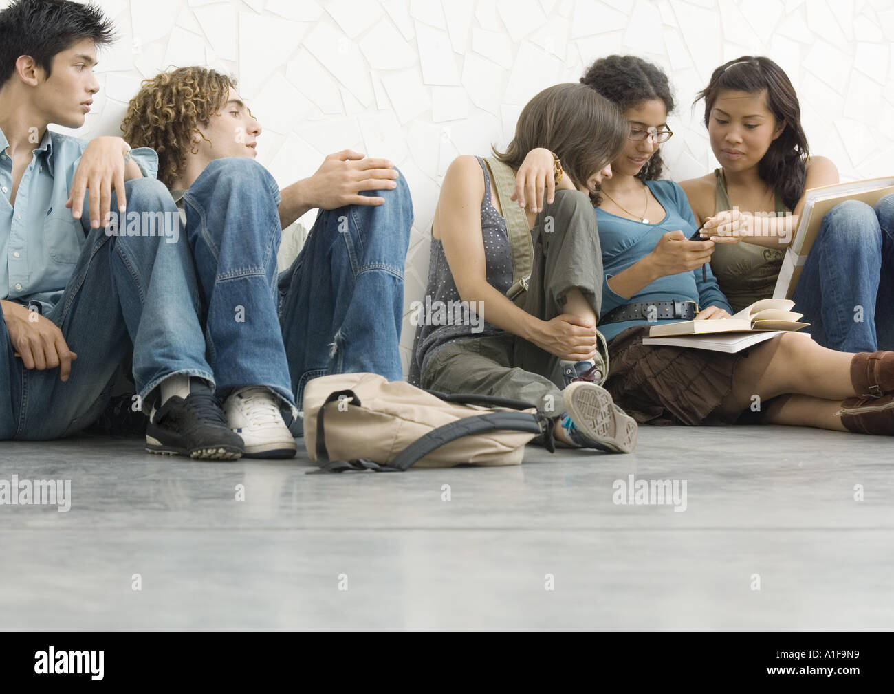 Group of students sitting on the floor Stock Photo - Alamy