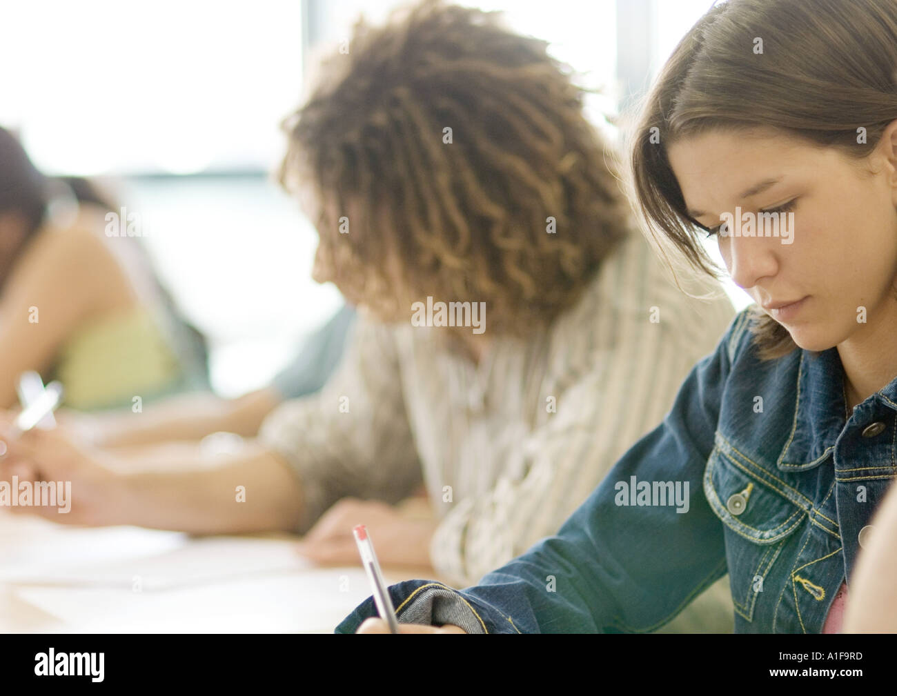 Students writing in class Stock Photo - Alamy