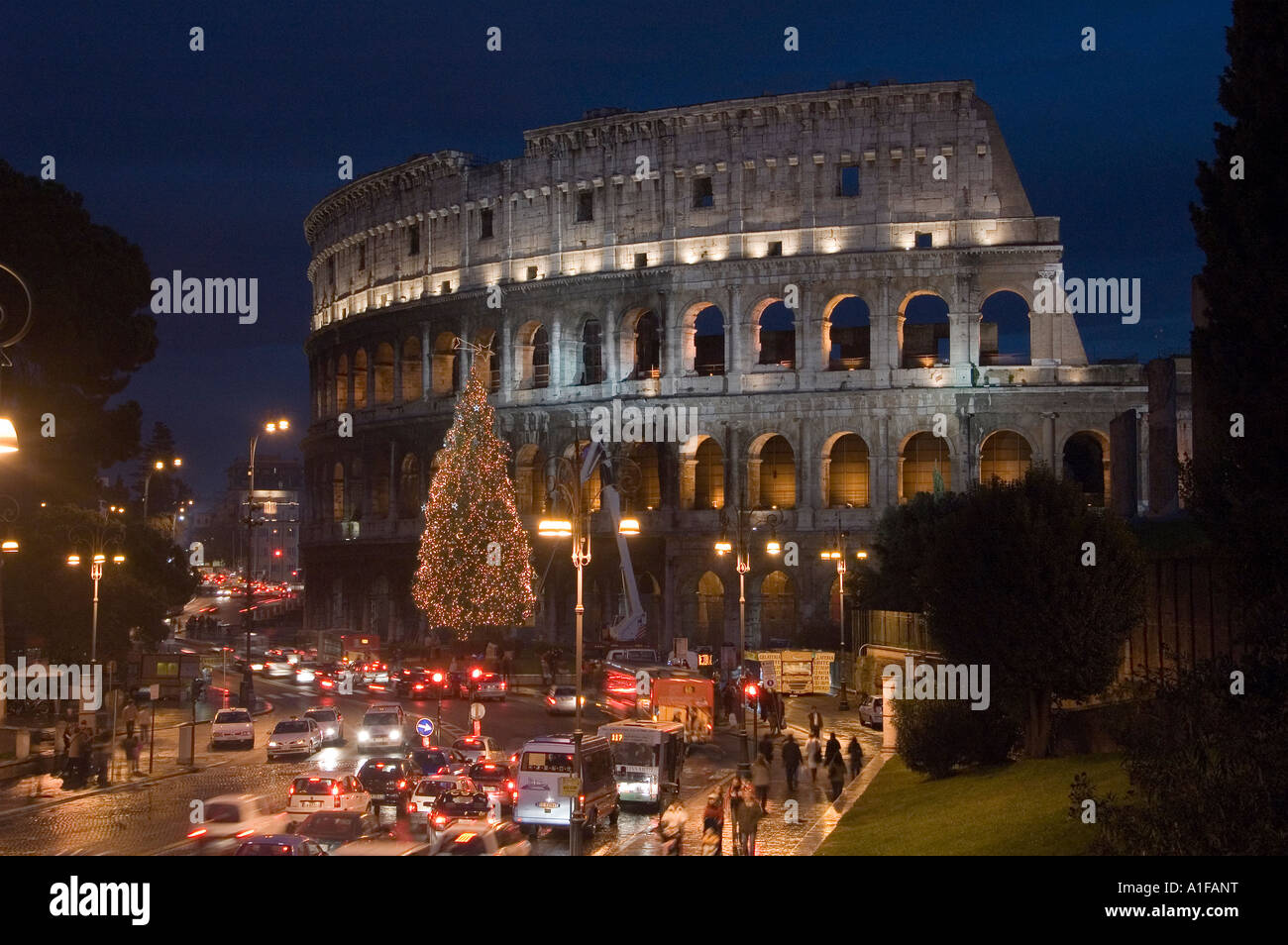 Exterior view of the Colosseum amphitheatre by night with illuminated ...