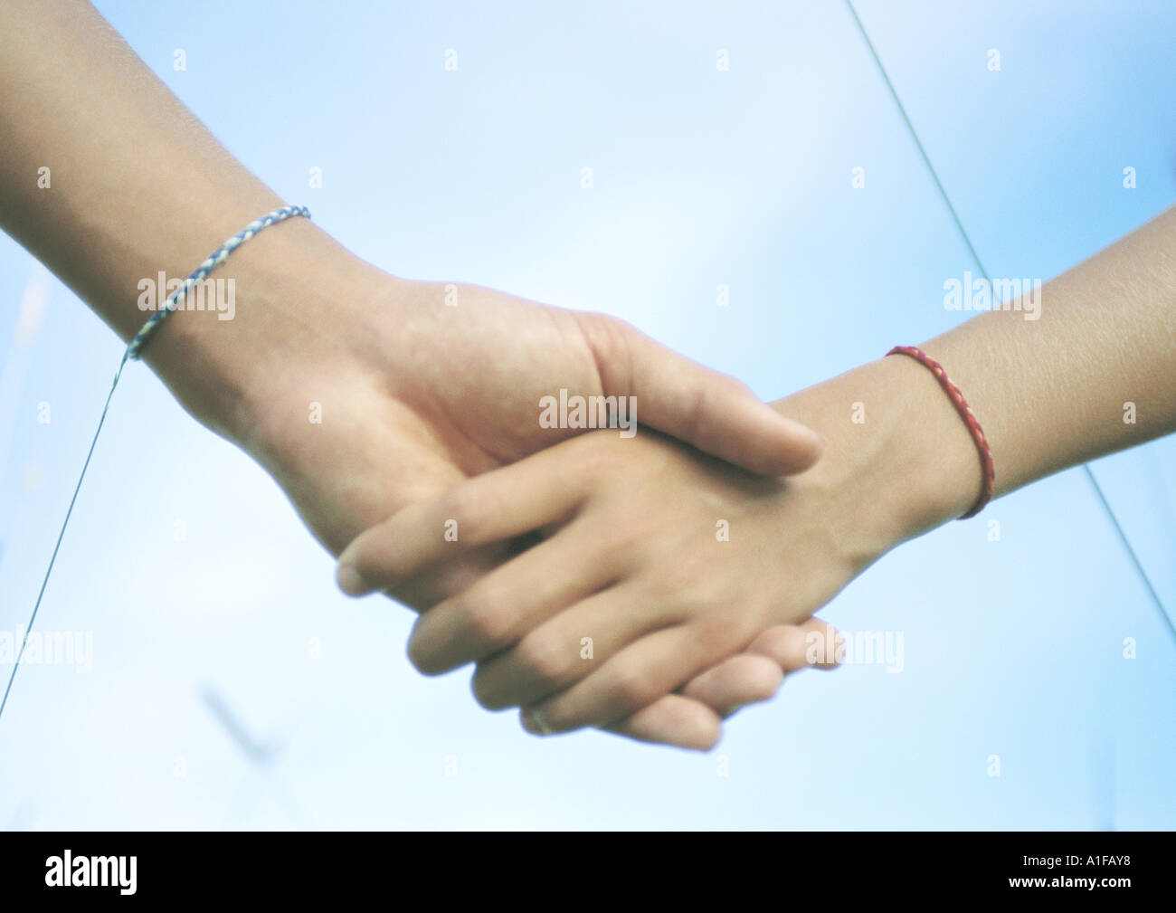 Two girls holding hands teens hi-res stock photography and images - Alamy
