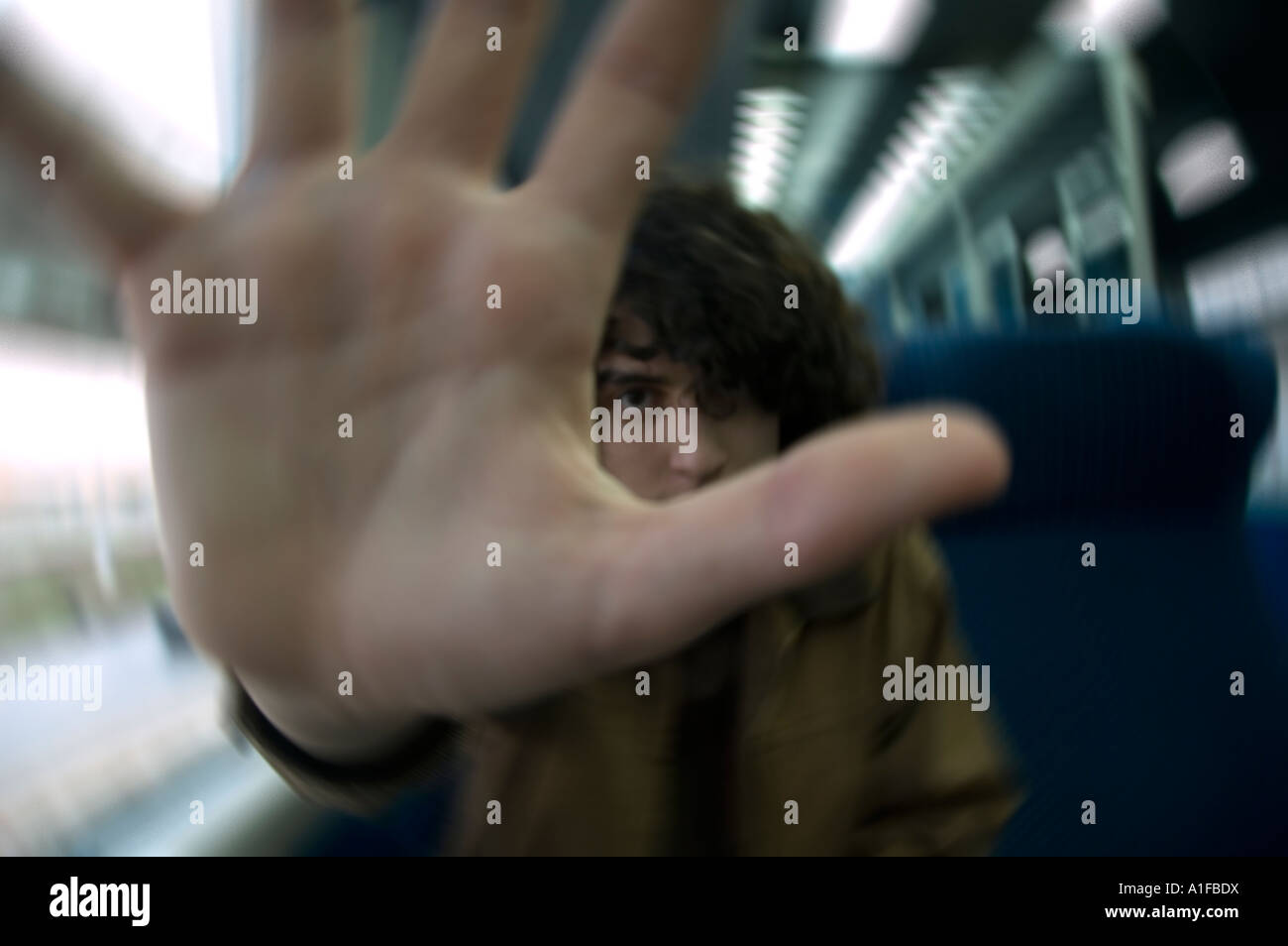 Youngster holding up his hand blocking photographer camera Stock Photo ...