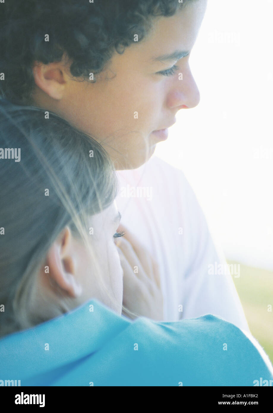 Teenage couple, girl leaning on boy's chest Stock Photo - Alamy