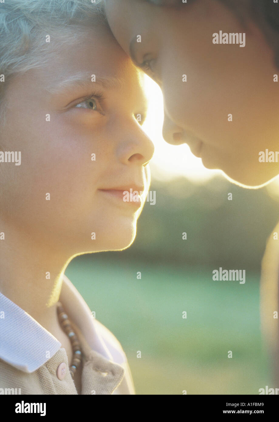 Boy and girl with foreheads touching Stock Photo - Alamy