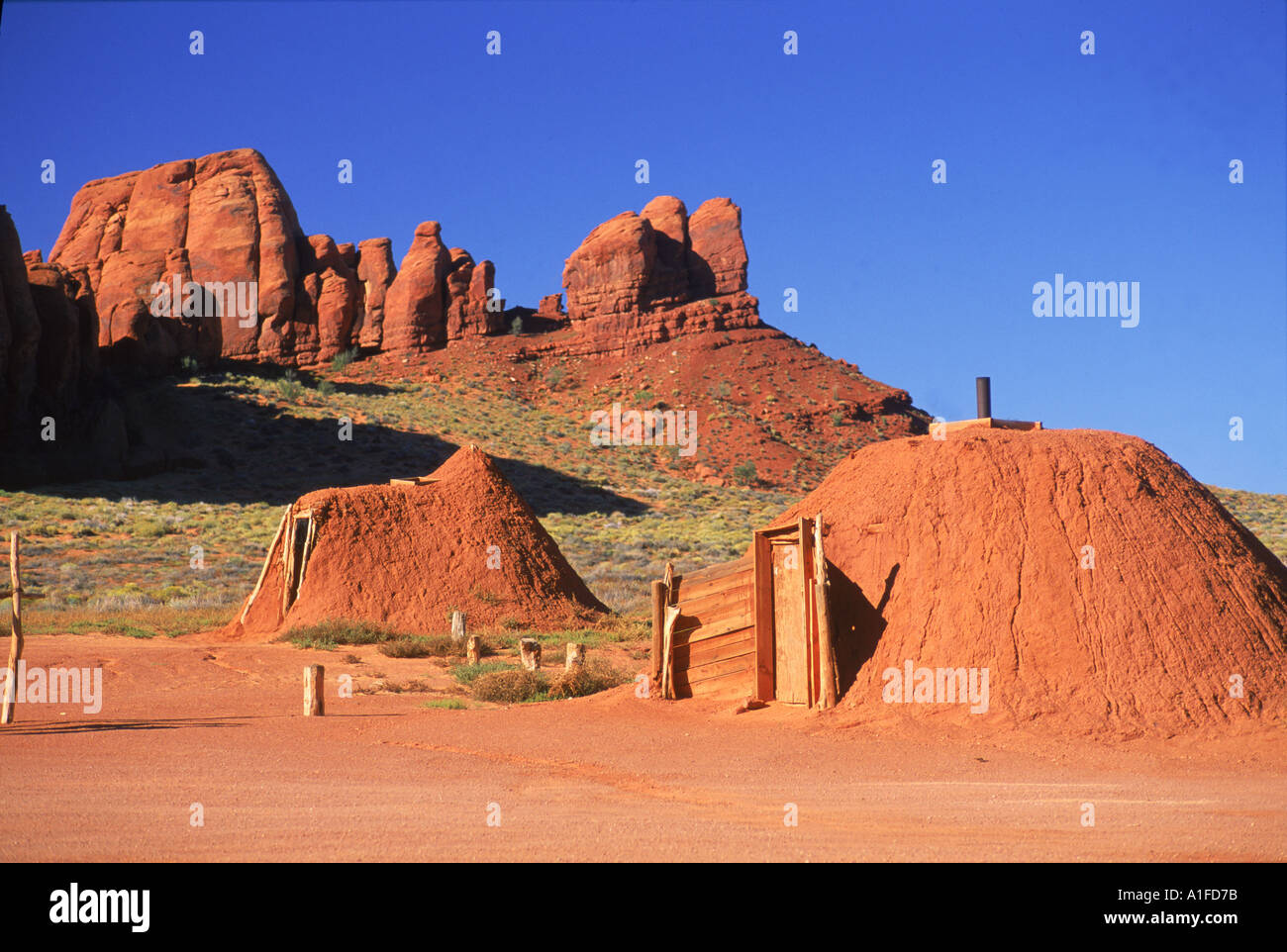 Male and female hogans earth built dwellings with rock formations in ...