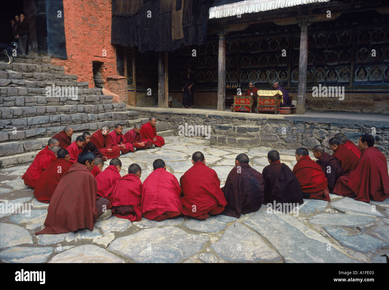 A group of young novice monks sitting in a circle during an oral ...