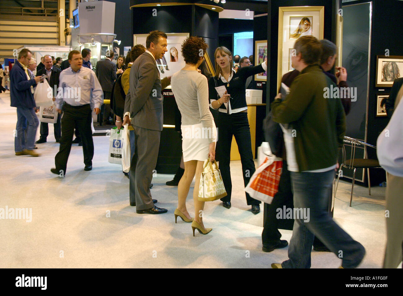 Visitors viewing exhibits at photographic exhibition and demonstration ...