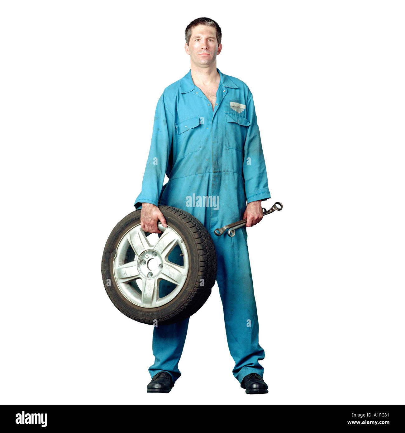 Mechanic holding wheel Stock Photo - Alamy