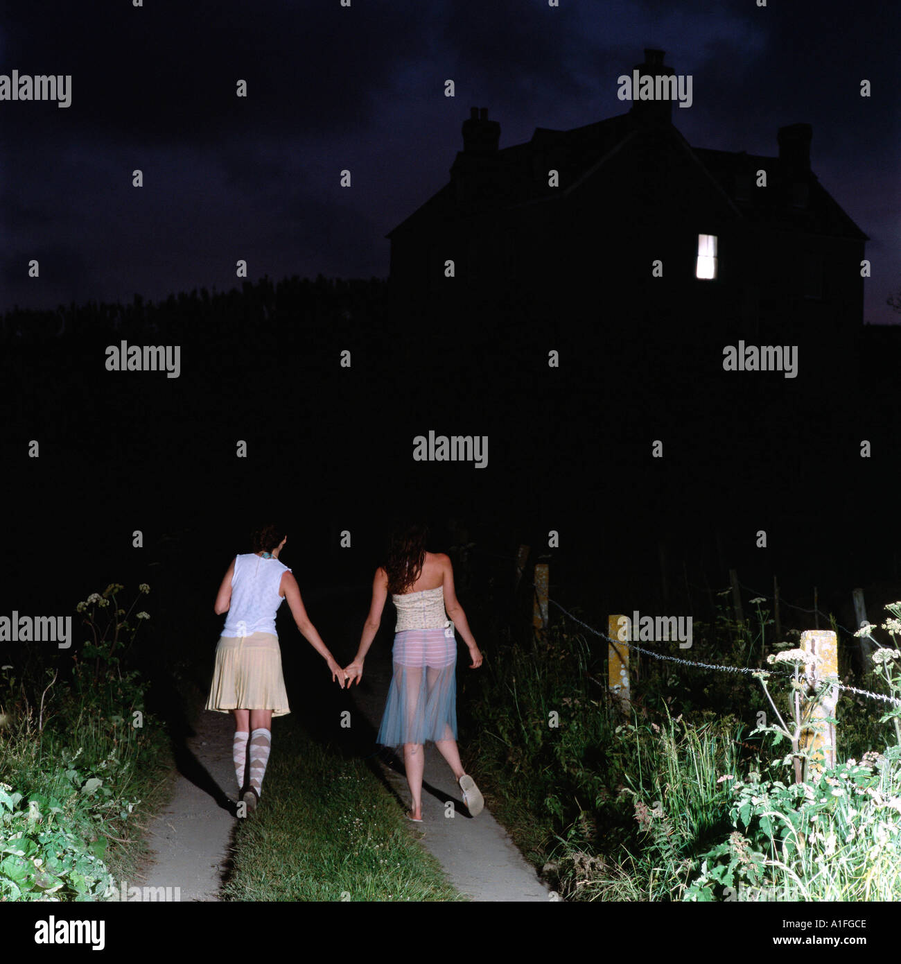 Girl walking at night rear view hi-res stock photography and images - Alamy