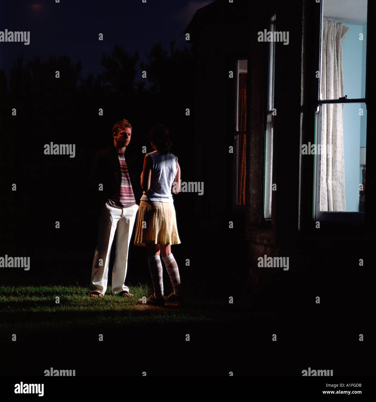 Man outside house night hi-res stock photography and images - Alamy