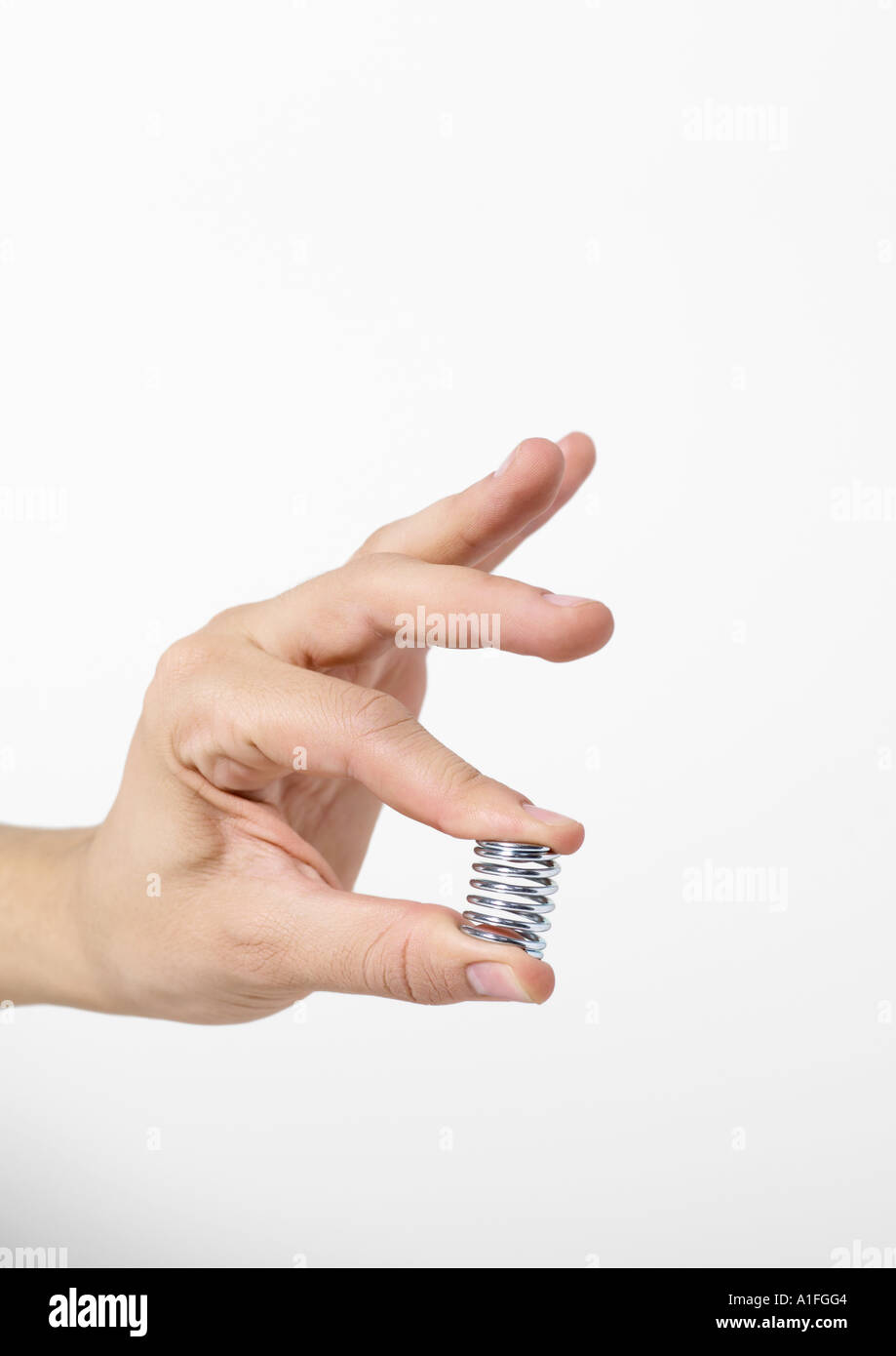 Hand holding spring Stock Photo - Alamy