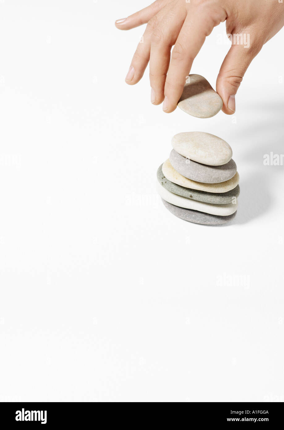 Hand stacking stones hi-res stock photography and images - Alamy