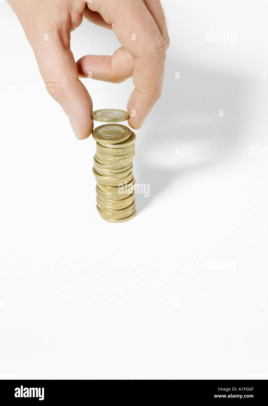 Hand stacking coins Stock Photo - Alamy