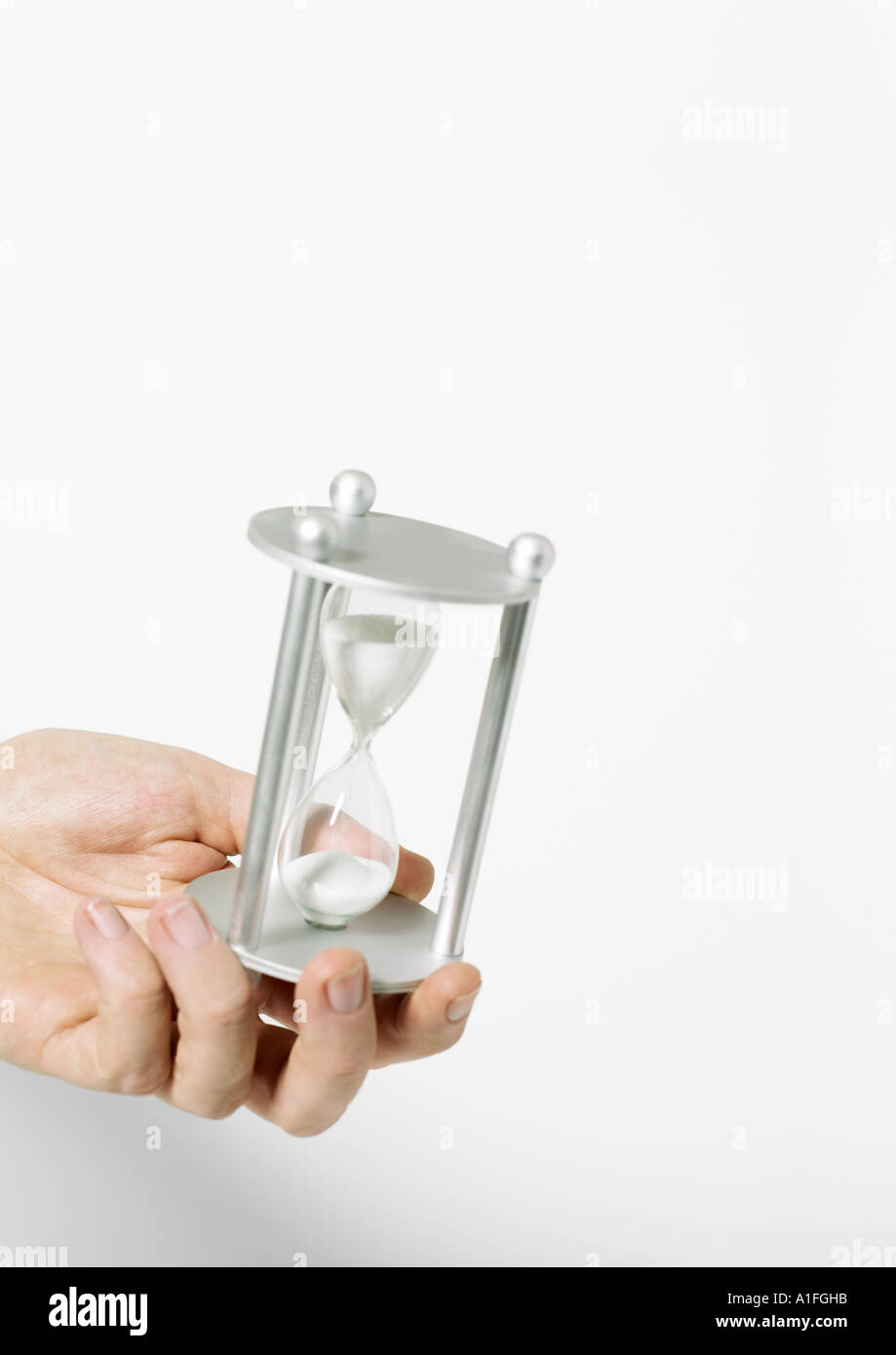 Hand holding hourglass Stock Photo - Alamy