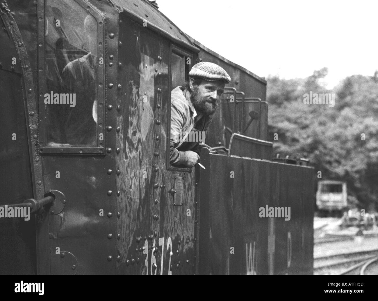 Engine driver leaning out of cab at Pickering station on North ...