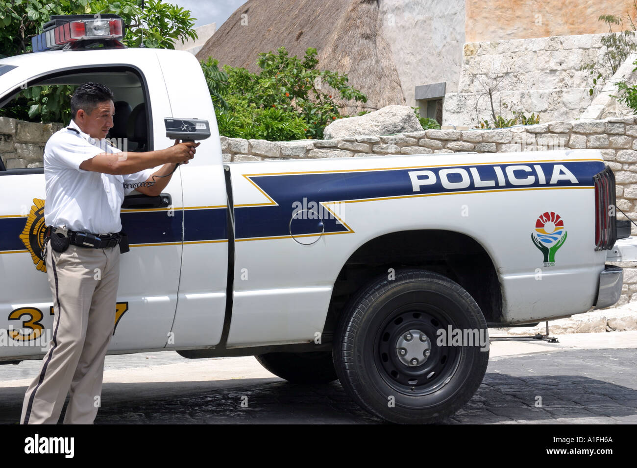 Policeman checking speed limit with a radar gun Cancun Mexico Stock ...