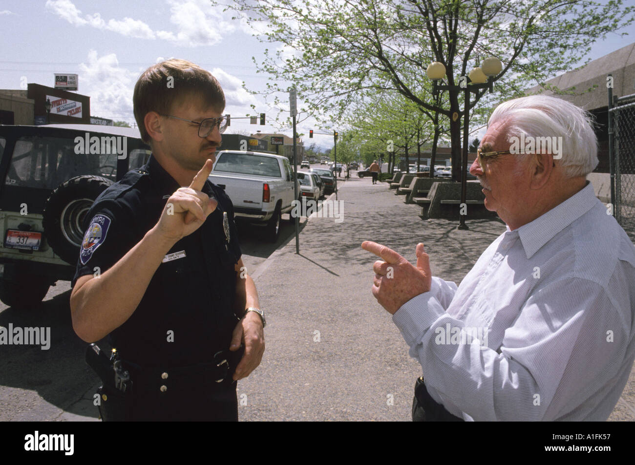 A policeman using sign language with a deaf man Stock Photo - Alamy