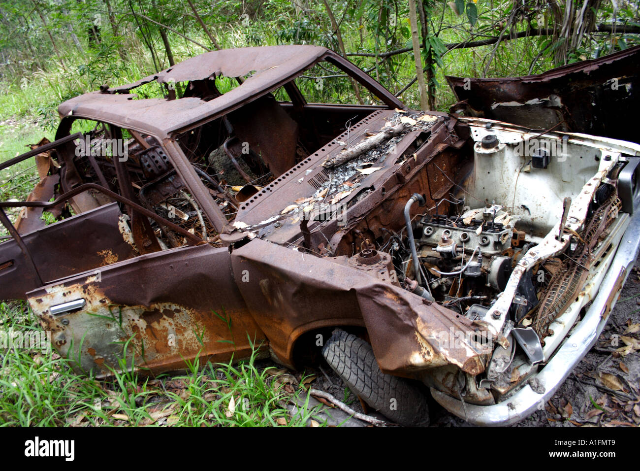 BURNT OUT SMASHED MOTOR VEHICLE DUMPED IN BUSH Stock Photo - Alamy