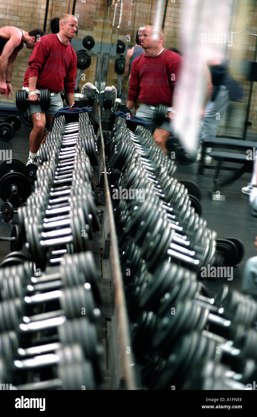 Keeping fit in a health club gym Stock Photo - Alamy