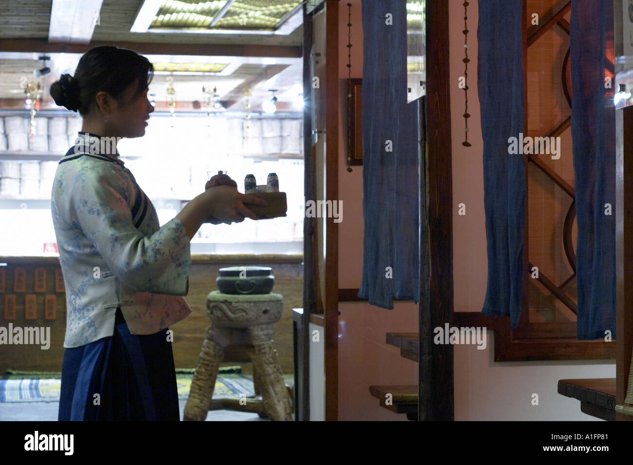 chinese waitress serves tea at guyuan antique teahouse in french ...
