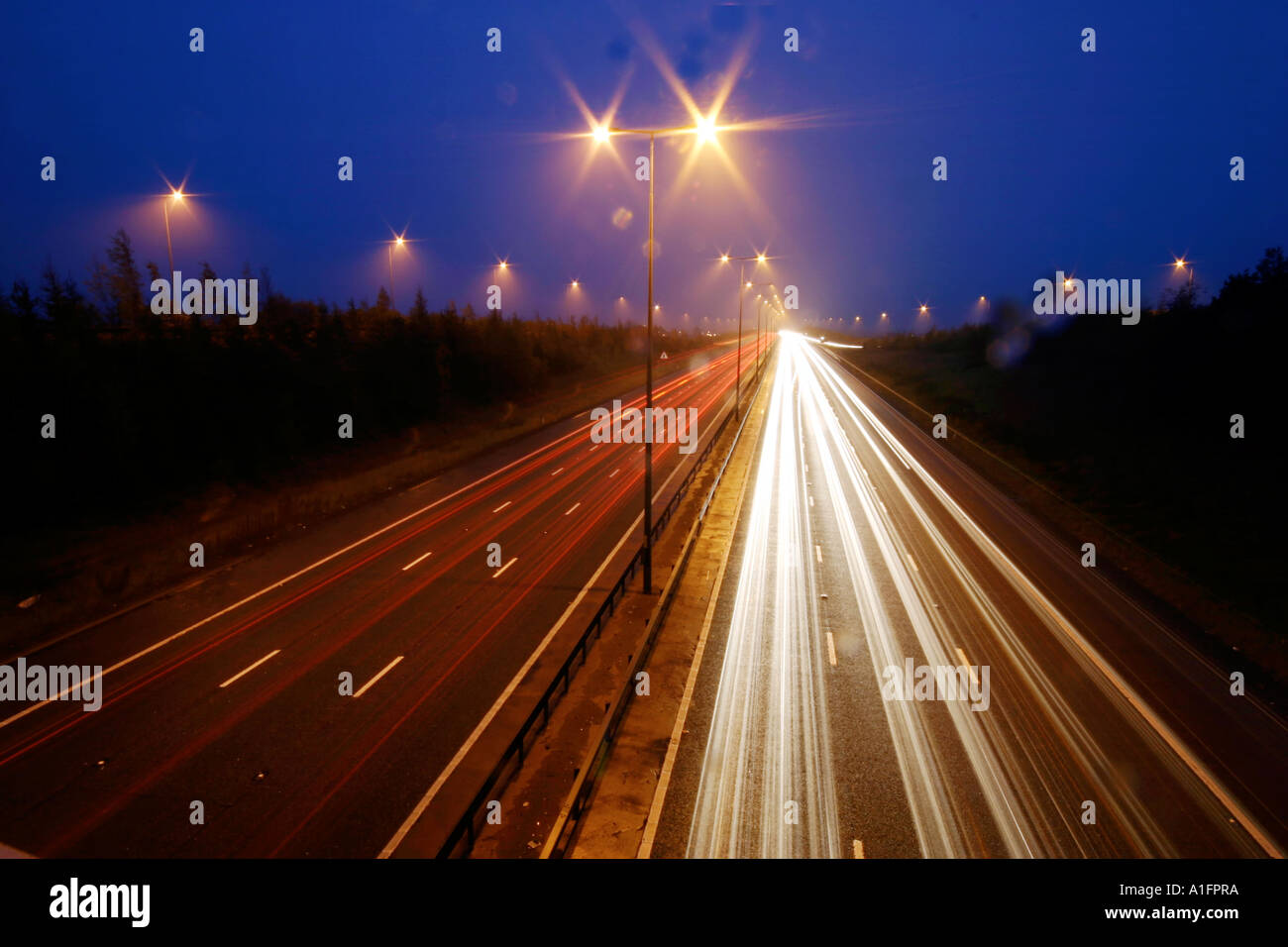 traffic trails on motorway at night from bridge overhead Stock Photo ...