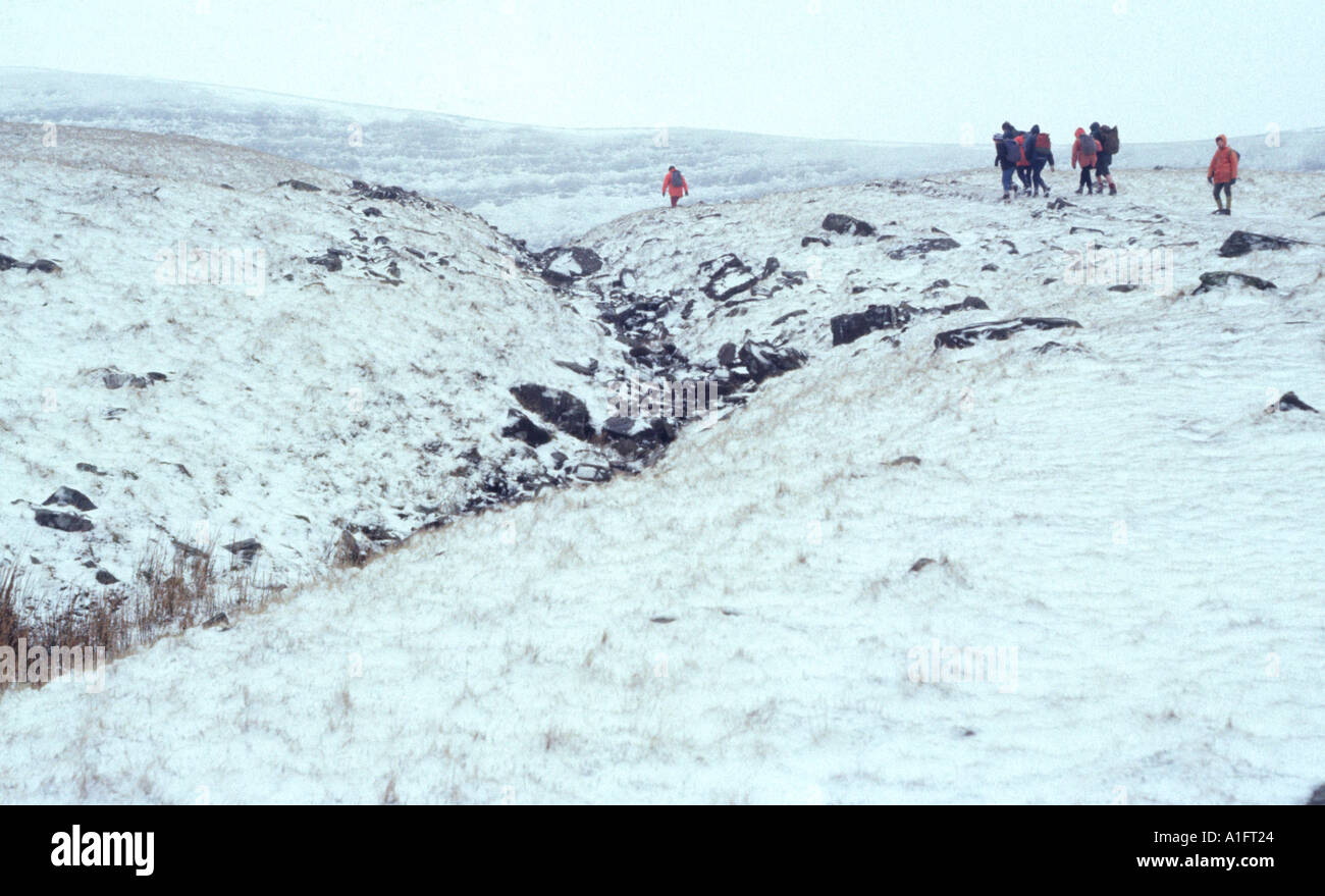 Snow covered corrie lip with party on school geography fieldtrip in ...
