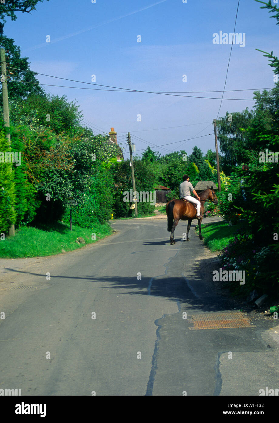 Horse and rider in the village of Urchfont Wiltshire England Stock ...