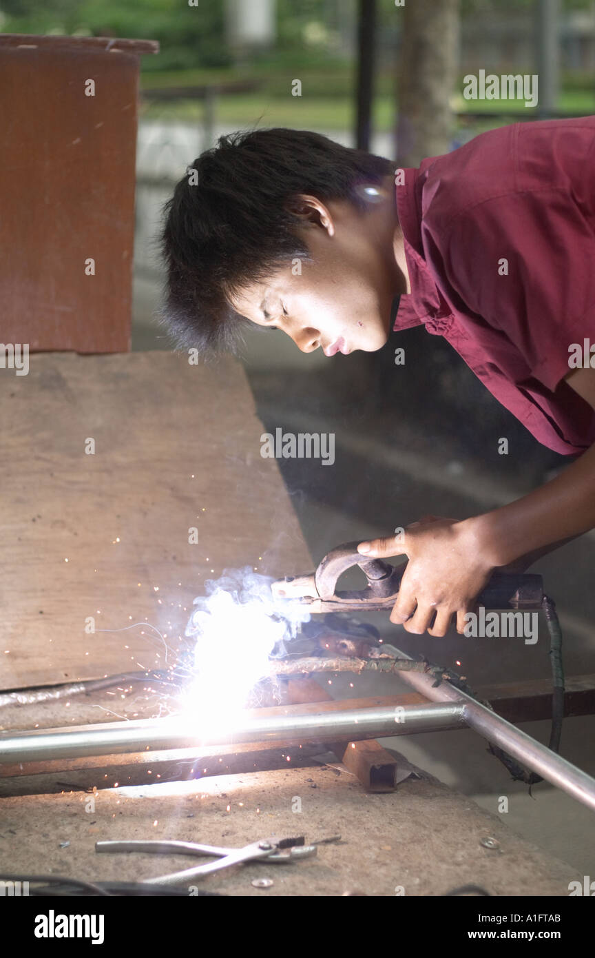 man weldingon the street in shanghai china Stock Photo - Alamy