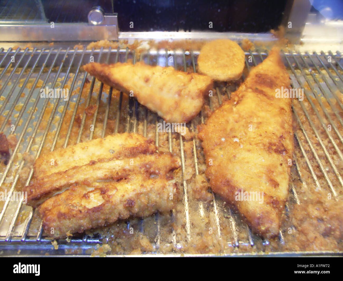 Fried battered fish English in Fish and Chip shop Stock Photo - Alamy