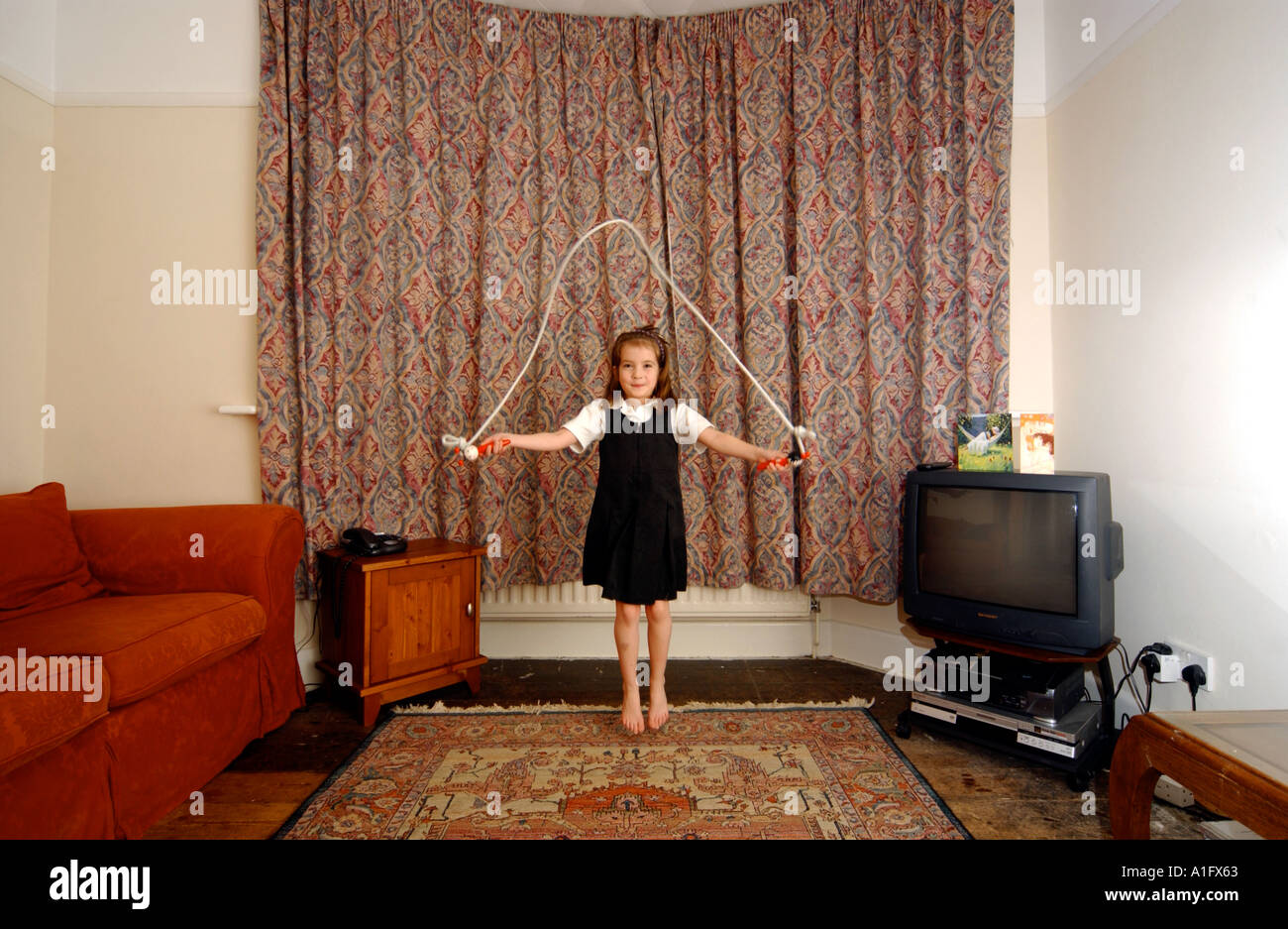 Girl playing with skipping rope hi-res stock photography and images - Alamy