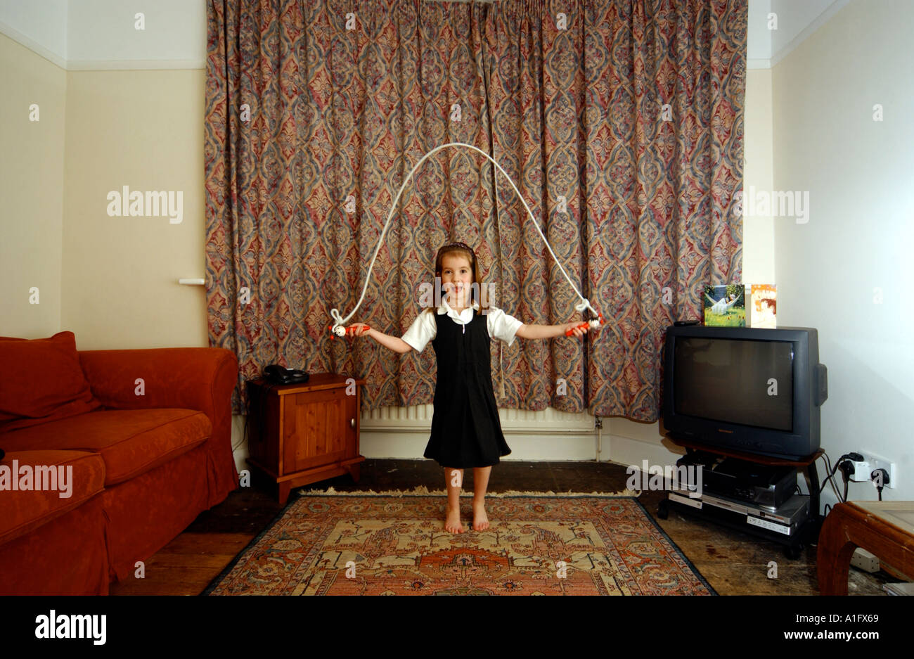Girl playing with skipping rope hi-res stock photography and images - Alamy