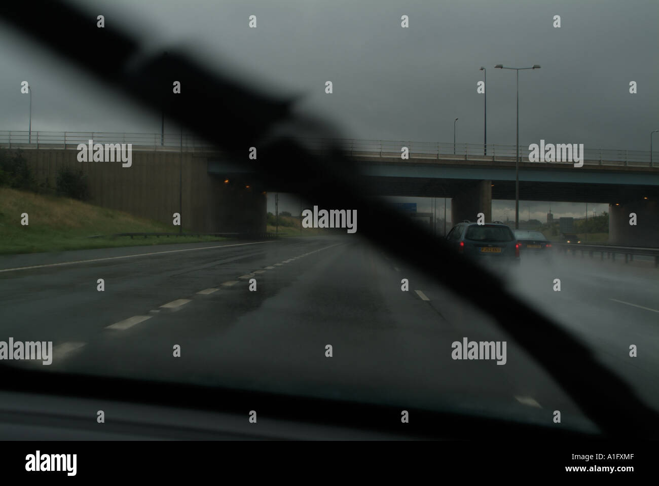 View through a windscreen as driving along a motorway in the UK in the ...