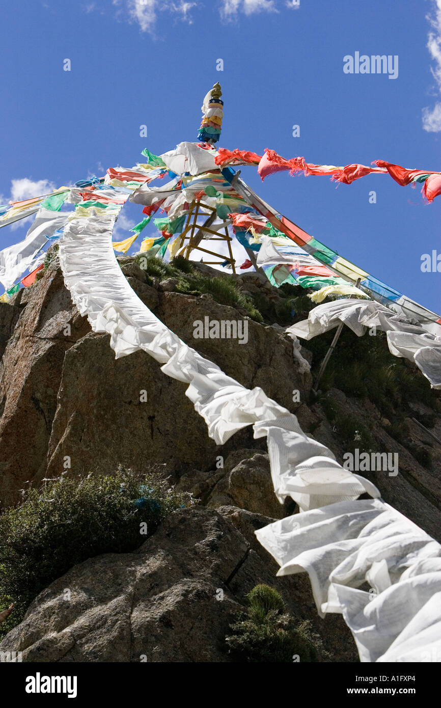 Tibetan prayer flags flying in the wind on rock outside temple Stock ...