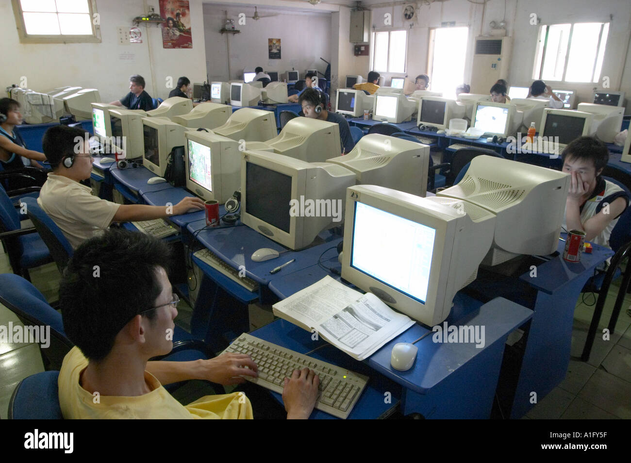 chinese people looking at computers playing games sending emails and ...