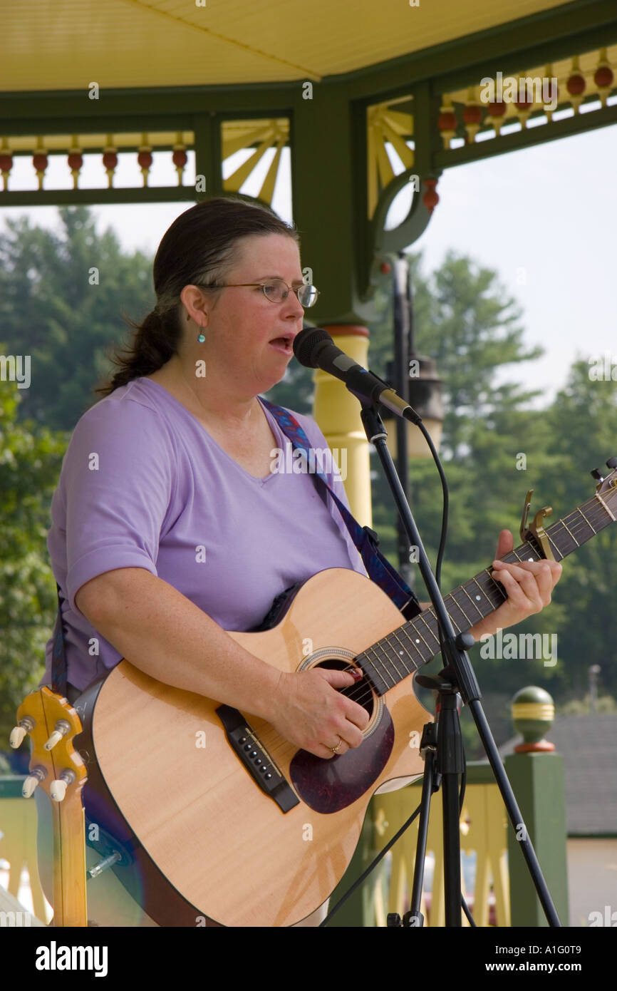 Singer/songwriter Amy Conely performs for the children at a farmer's ...