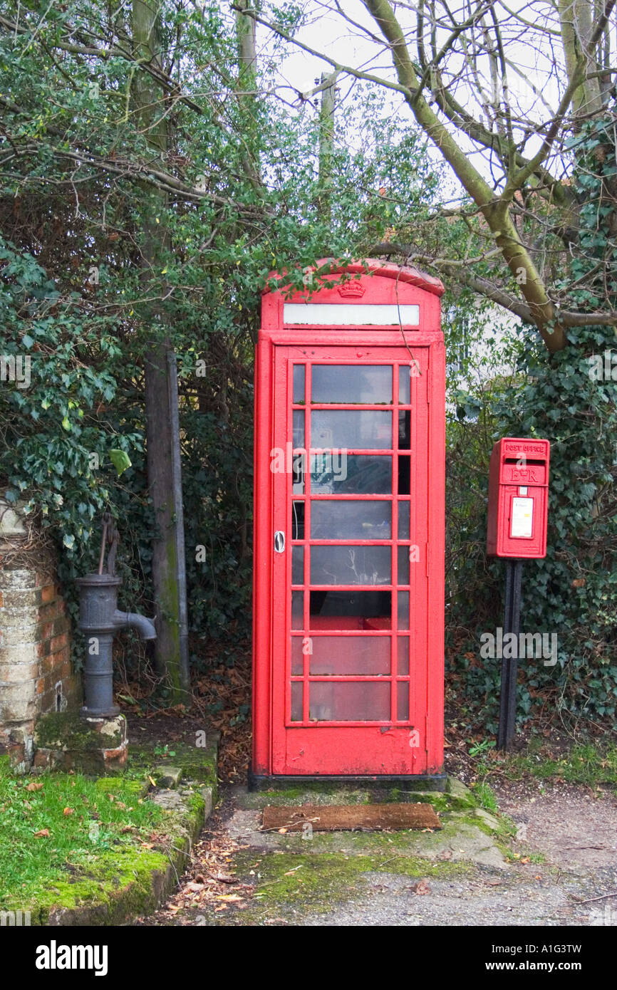 Red public telephone box with postal box and old pump Copford Essex ...