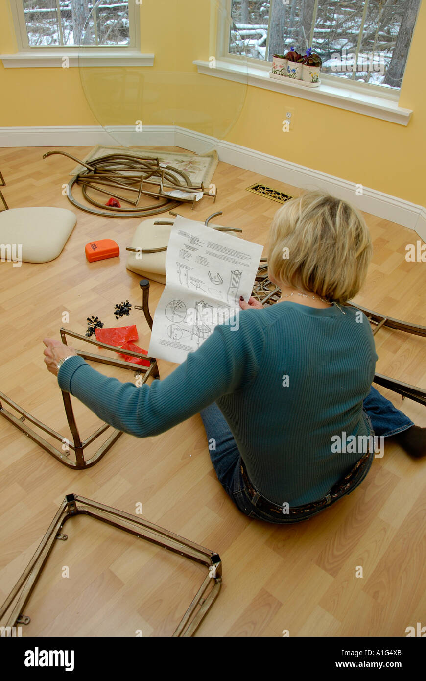 Self sufficient woman reads directions and assembles a do it yourself ...